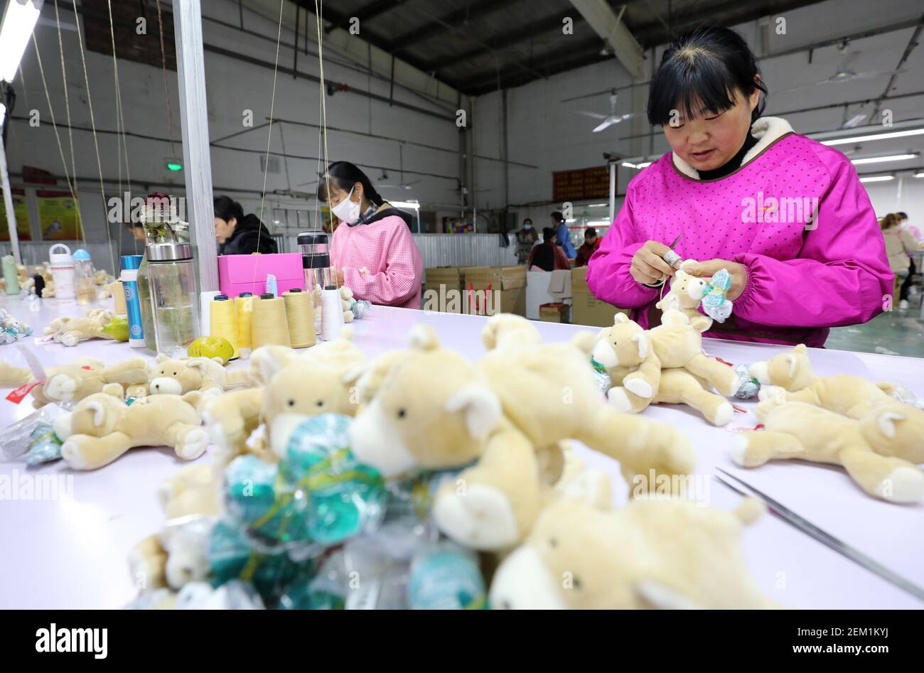 Factory workers make stuffed animals at a production workshop of a toy ...