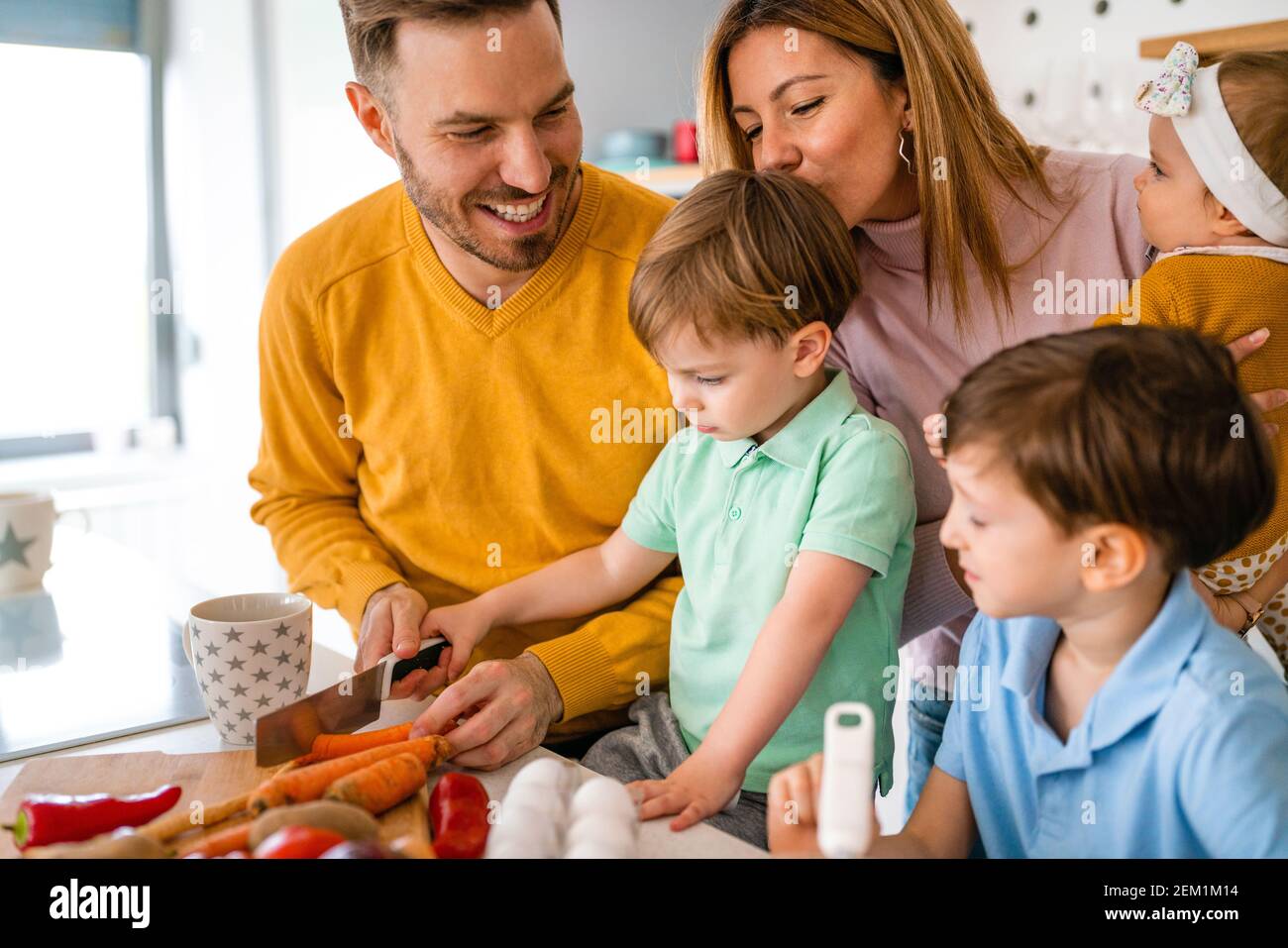 Happy family in the kitchen having fun and cooking together Stock Photo ...