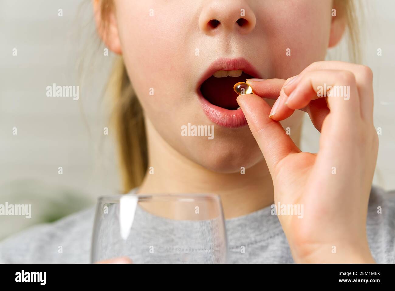 girl eating white pills medicine tablet and drink glass of water Stock ...