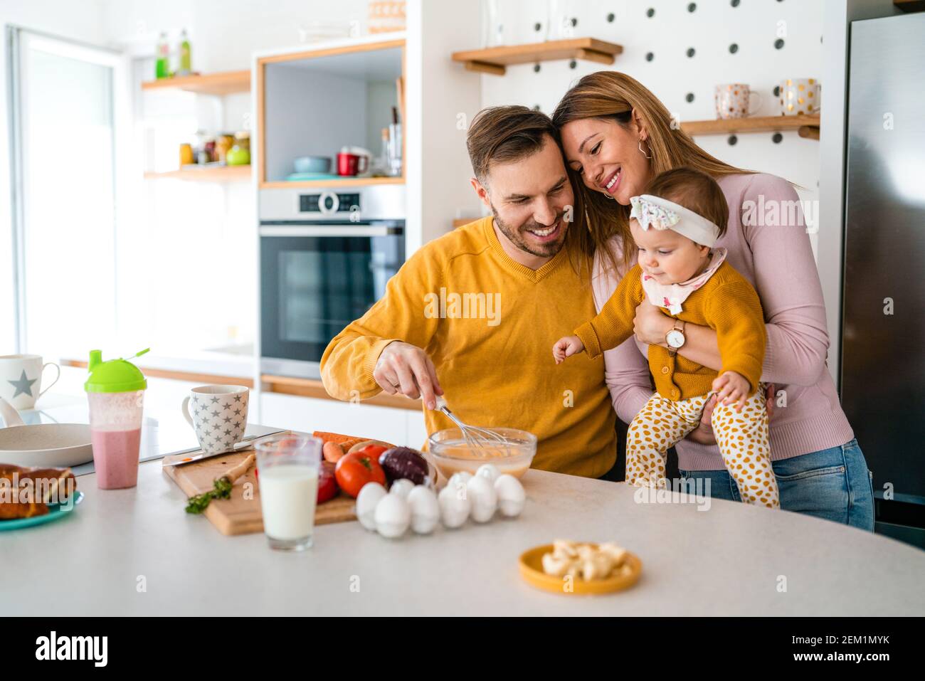 Happy family in the kitchen having fun and cooking together Stock Photo ...