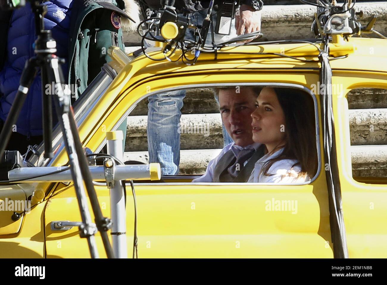 Actor Tom Cruise and actress Hayley Atwell in a Fiat yellow 500 driven ...