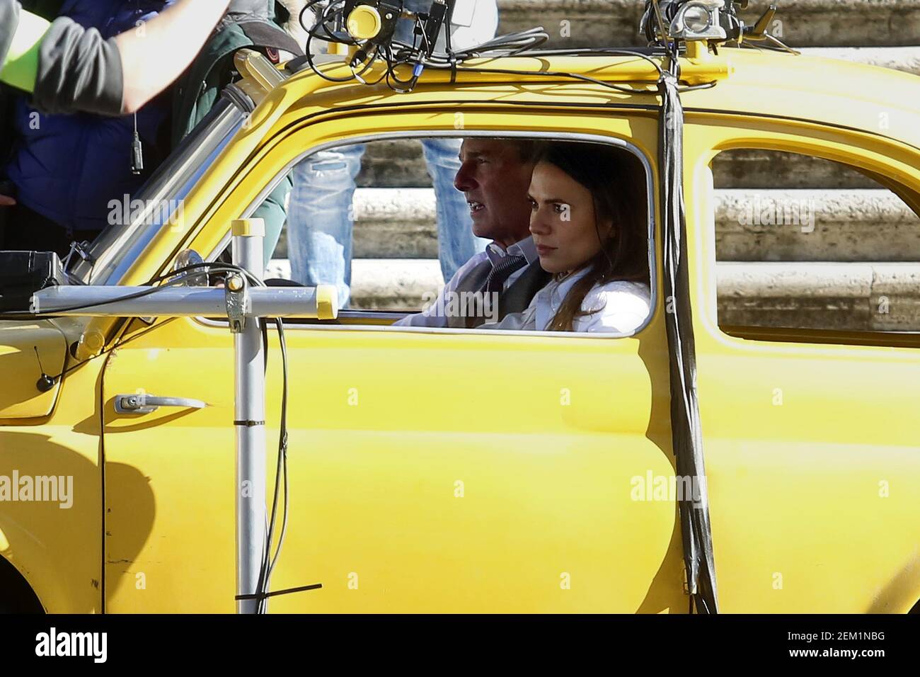 Actor Tom Cruise and actress Hayley Atwell in a Fiat yellow 500 driven ...