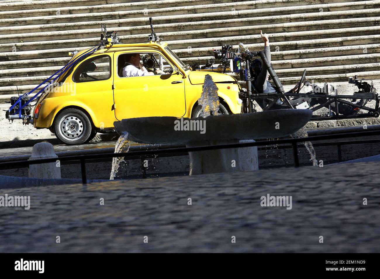 Actor Tom Cruise and actress Hayley Atwell in a Fiat yellow 500 driven ...