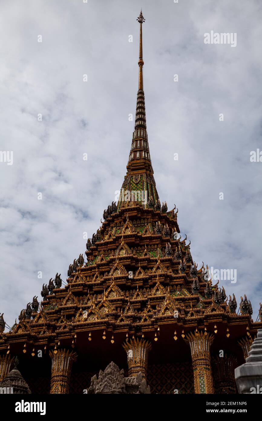 View of a golden spire of a temple standing out against the sky at the ...