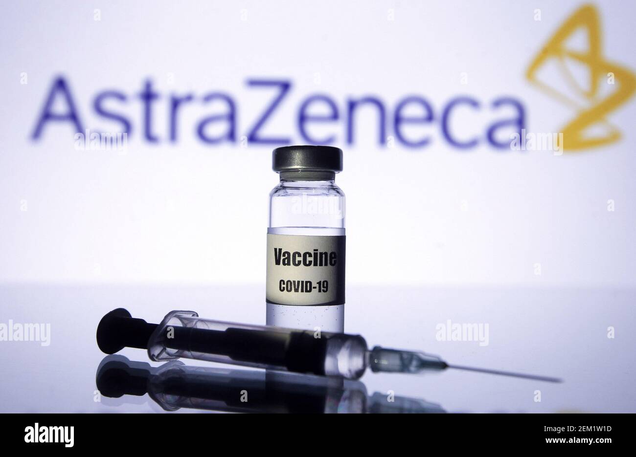 In this photo illustration a medical syringe and a vial with COVID-19 ...