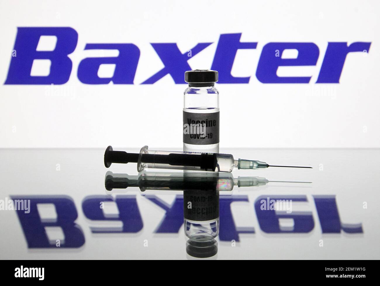 In this photo illustration a medical syringe and a vial with COVID-19 ...