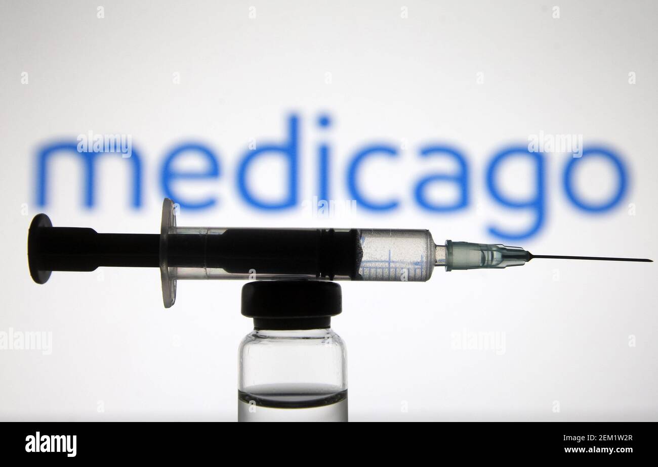 In this photo illustration a medical syringe and a vial with COVID-19 ...