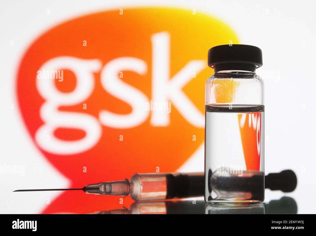 In this photo illustration a medical syringe and a vial with COVID-19 ...