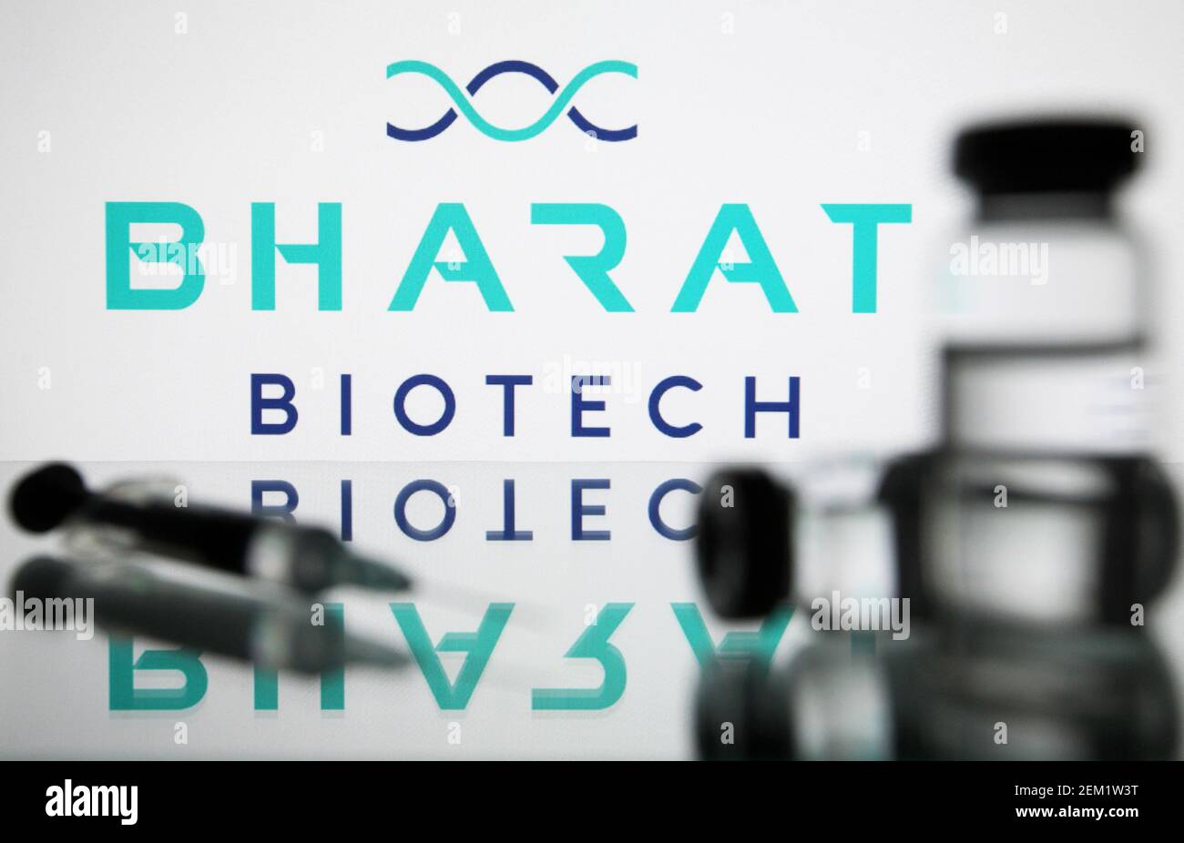 In this photo illustration a medical syringe and a vial with COVID-19 ...