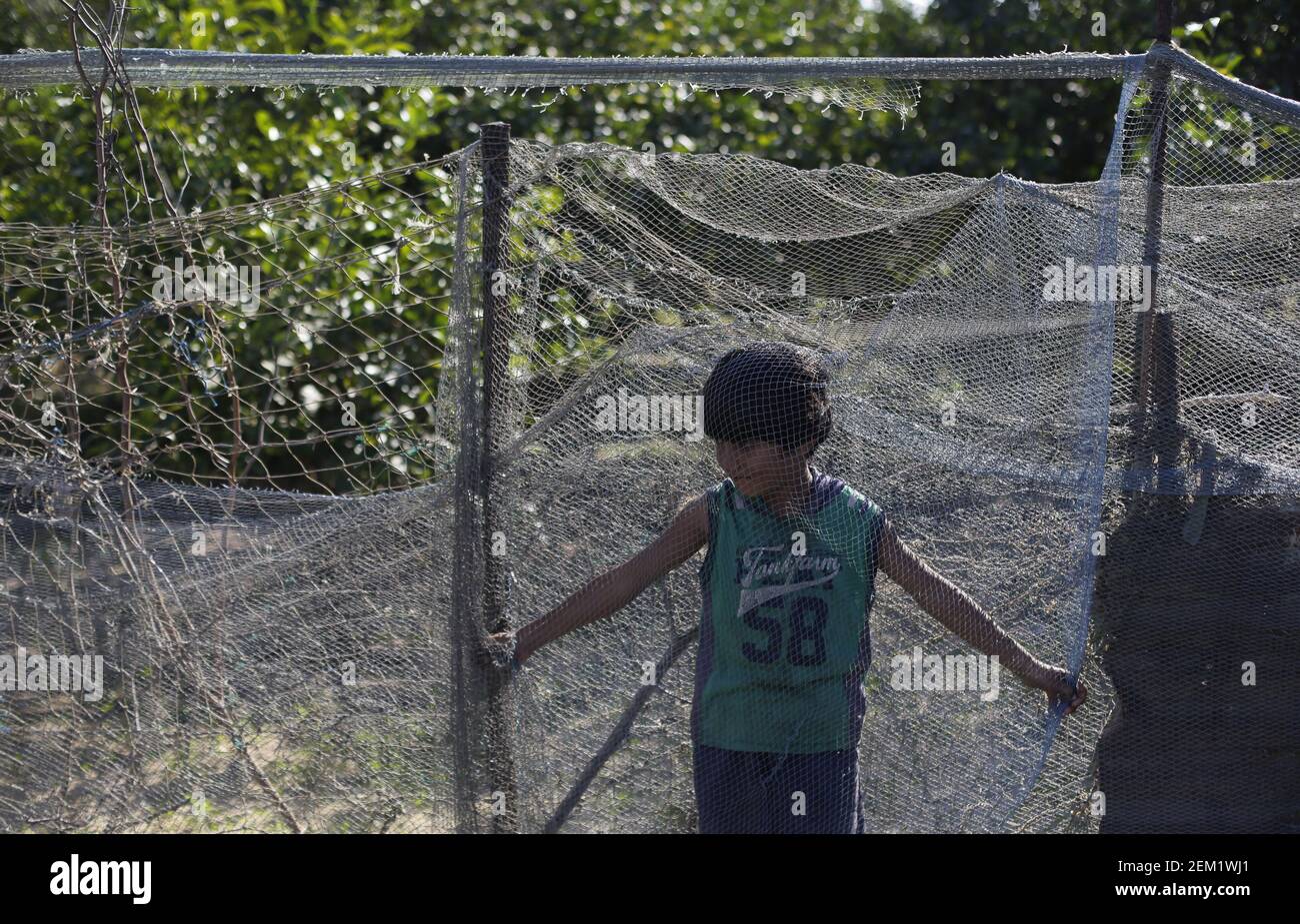 A Palestinian boy plays outside their home in the northern Gaza Strip ...