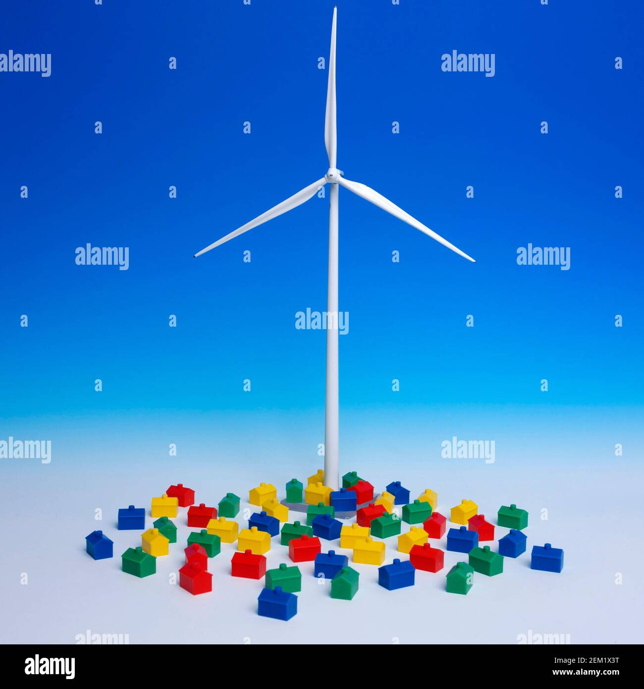 A wind turbine amidst colorful blocks on a bright blue backdrop ...