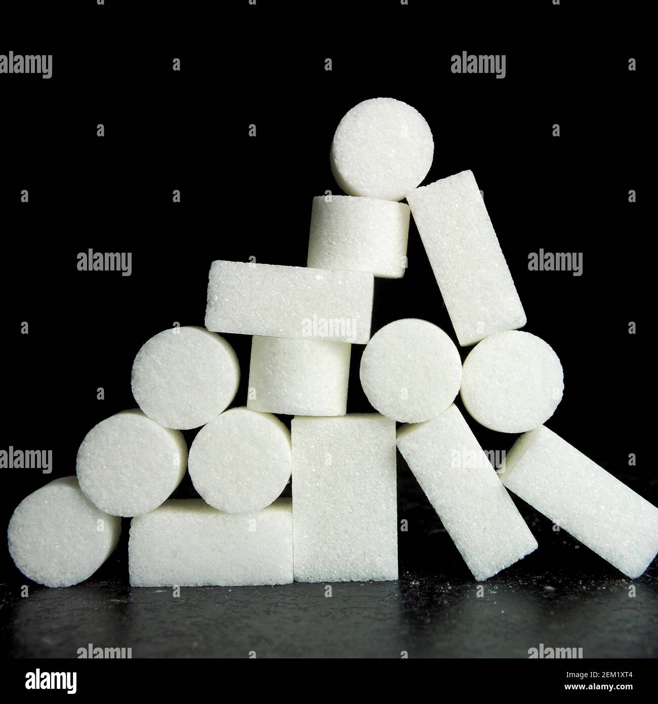 A creative stack of white sugar cubes arranged in a pyramid formation ...