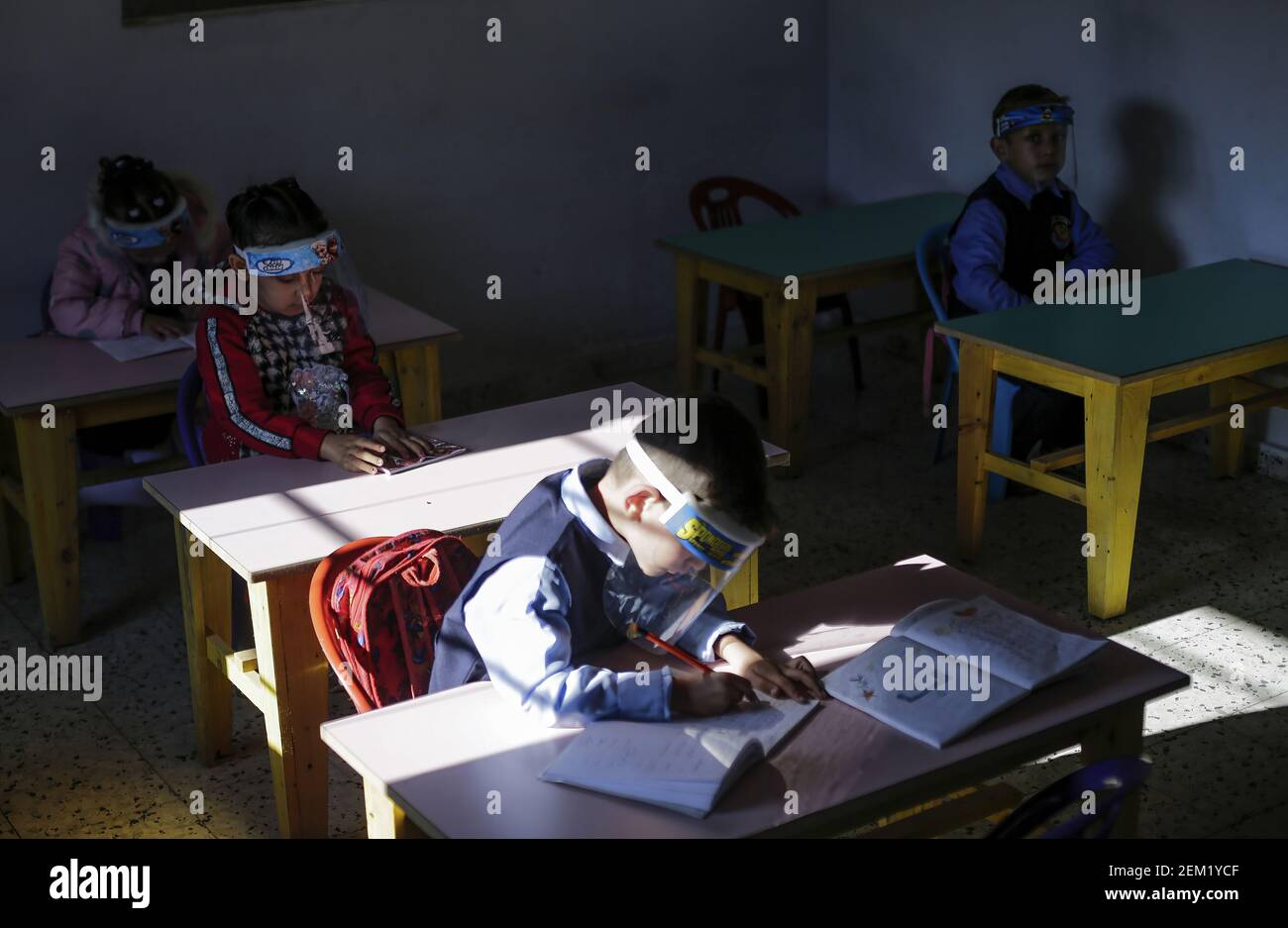 Palestinian kindergarten children wearing face shields as a precaution ...