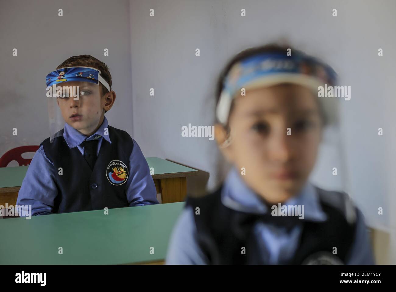 A Palestinian kindergarten child wearing a face shield as a precaution ...