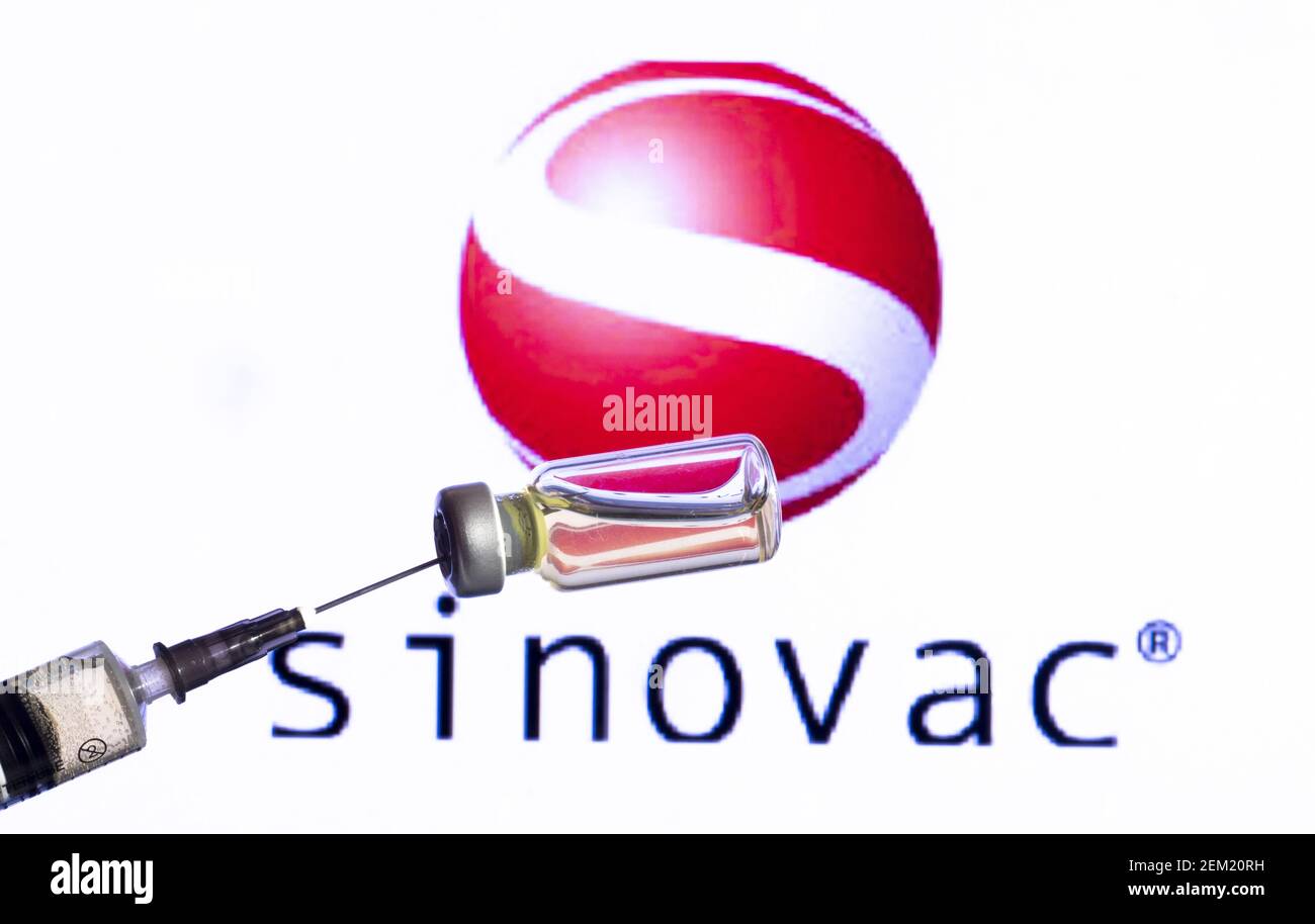 In this photo illustration a medical syringe with a bottle of liquid ...