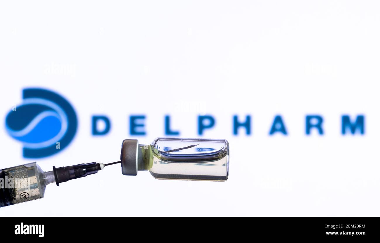 In this photo illustration a medical syringe with a bottle of liquid ...