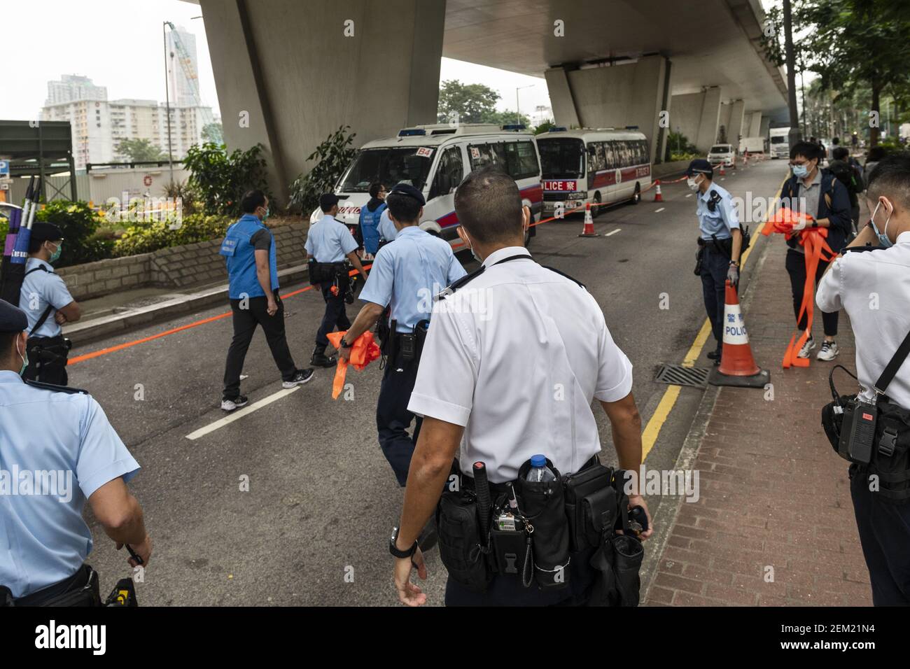 Police officers leave the West Kowloon Law Courts building premises ...