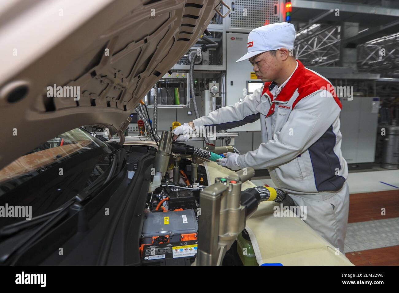 TAIZHOU, CHINA - NOVEMBER 24, 2020 - A worker works on an assembly line ...