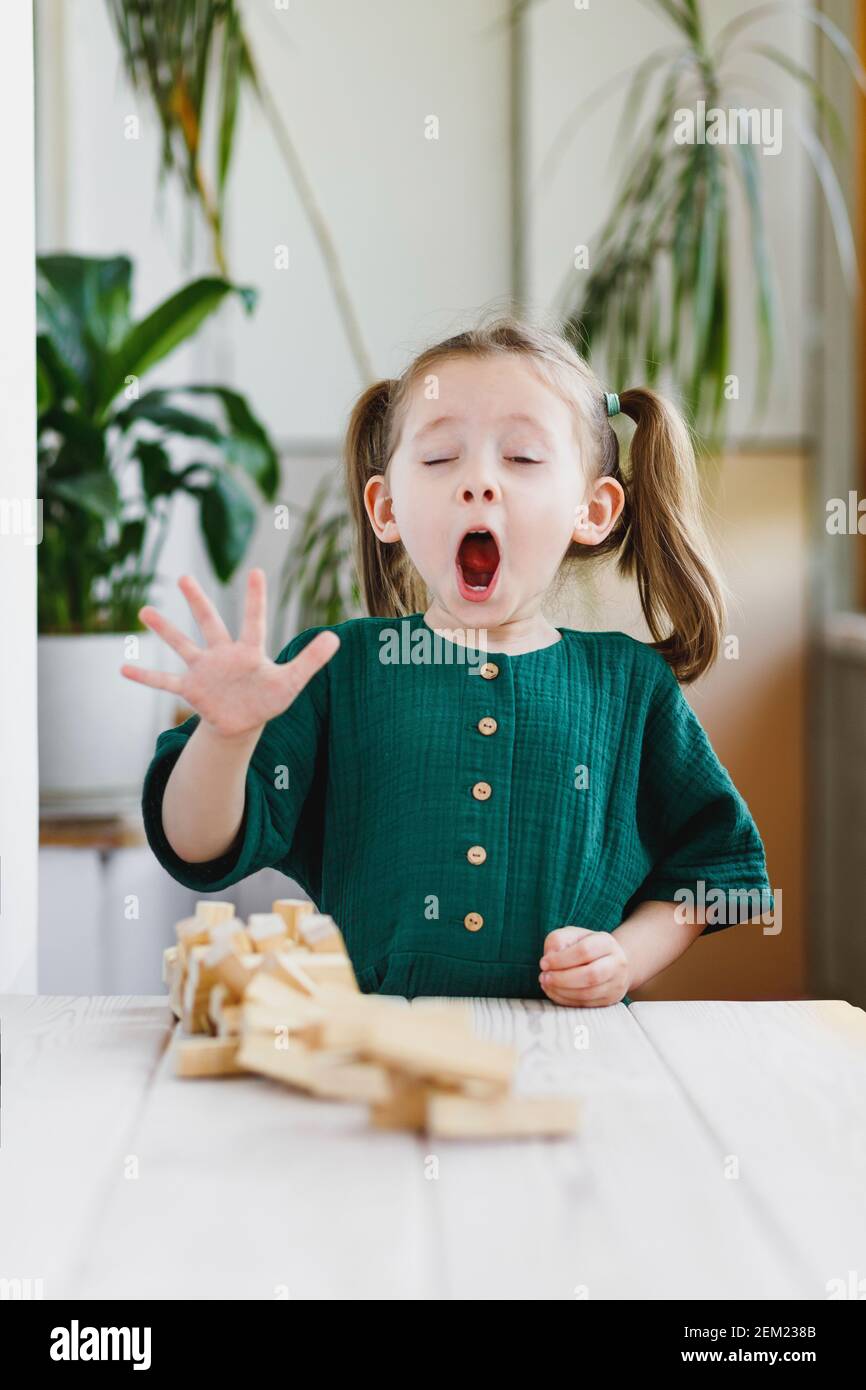 Preschool age girl expressive reaction on unexpected falling of wooden ...
