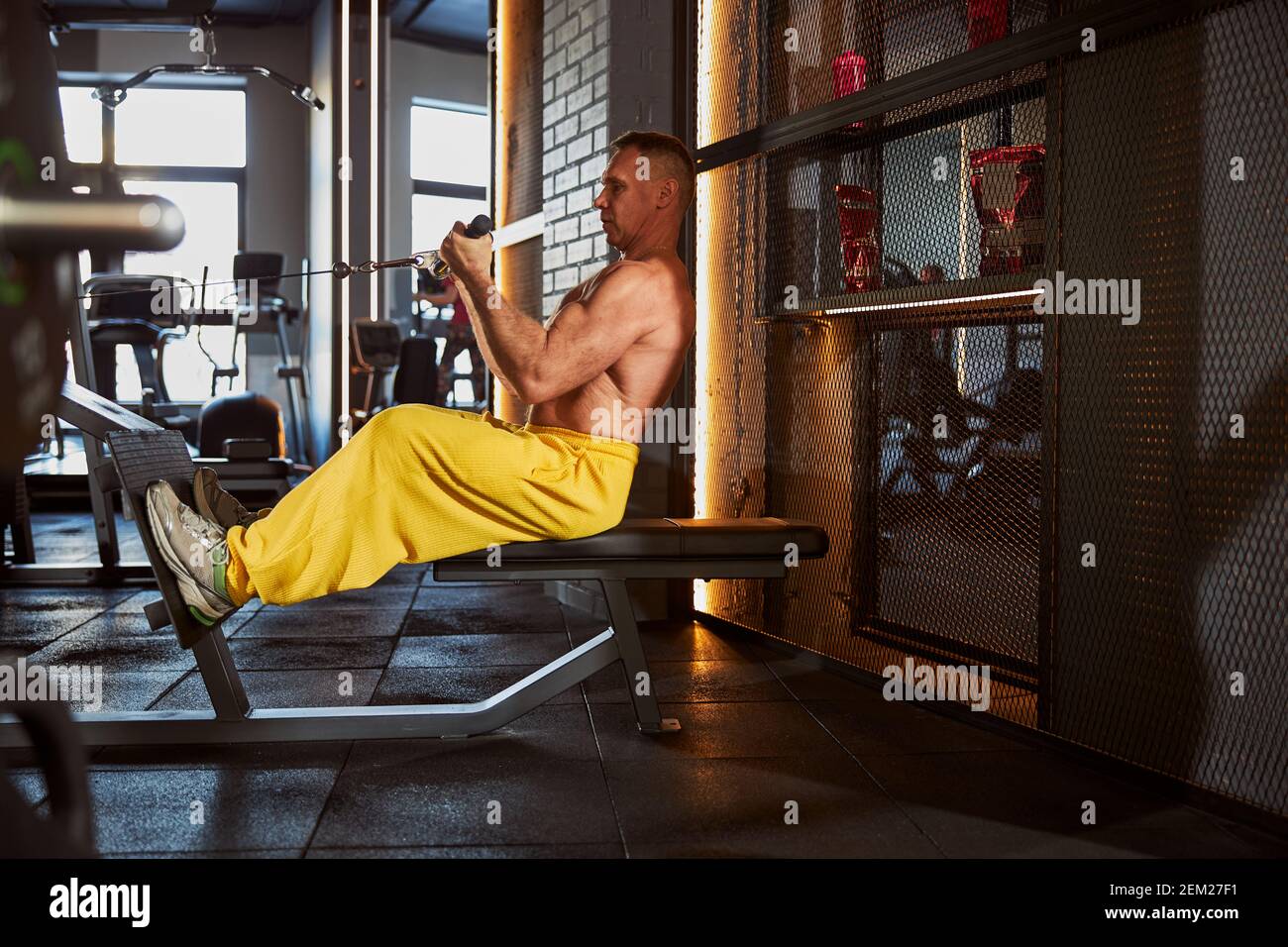 Upper body exercise day for athletic man in yellow pants Stock Photo ...