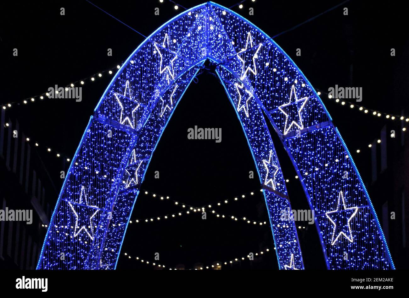 Blue archway of stars with strings of white lights connecting the ...
