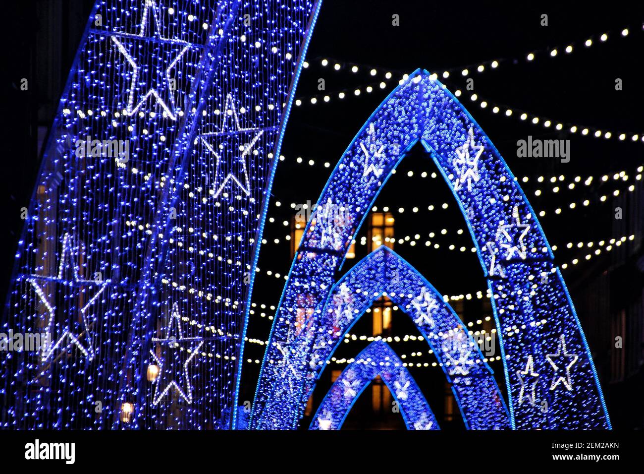 Blue archway of stars with strings of white lights connecting the ...