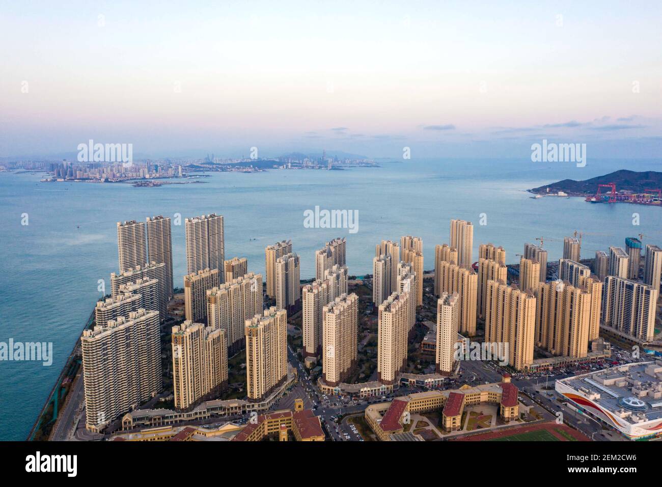 An urban community is lined with tall buildings and beautiful scenery ...