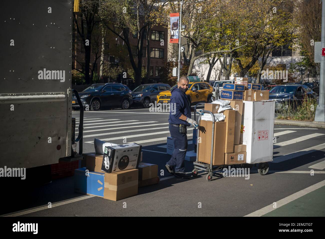 Deliverymen from FedEx sort packages in the Chelsea neighborhood of New ...