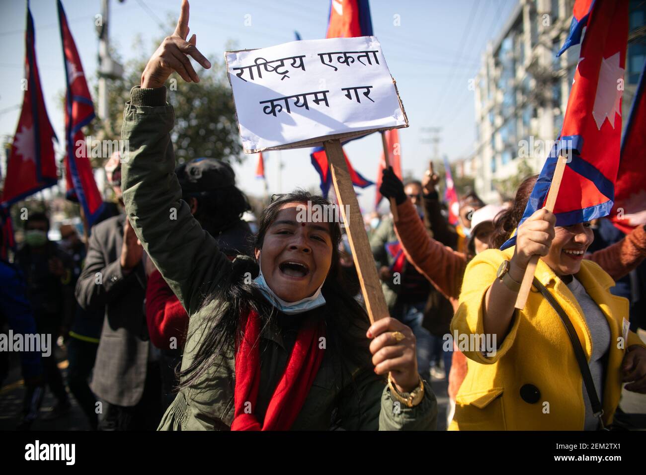 A Nepalese woman holds a placard during a pro-monarchy demonstration ...