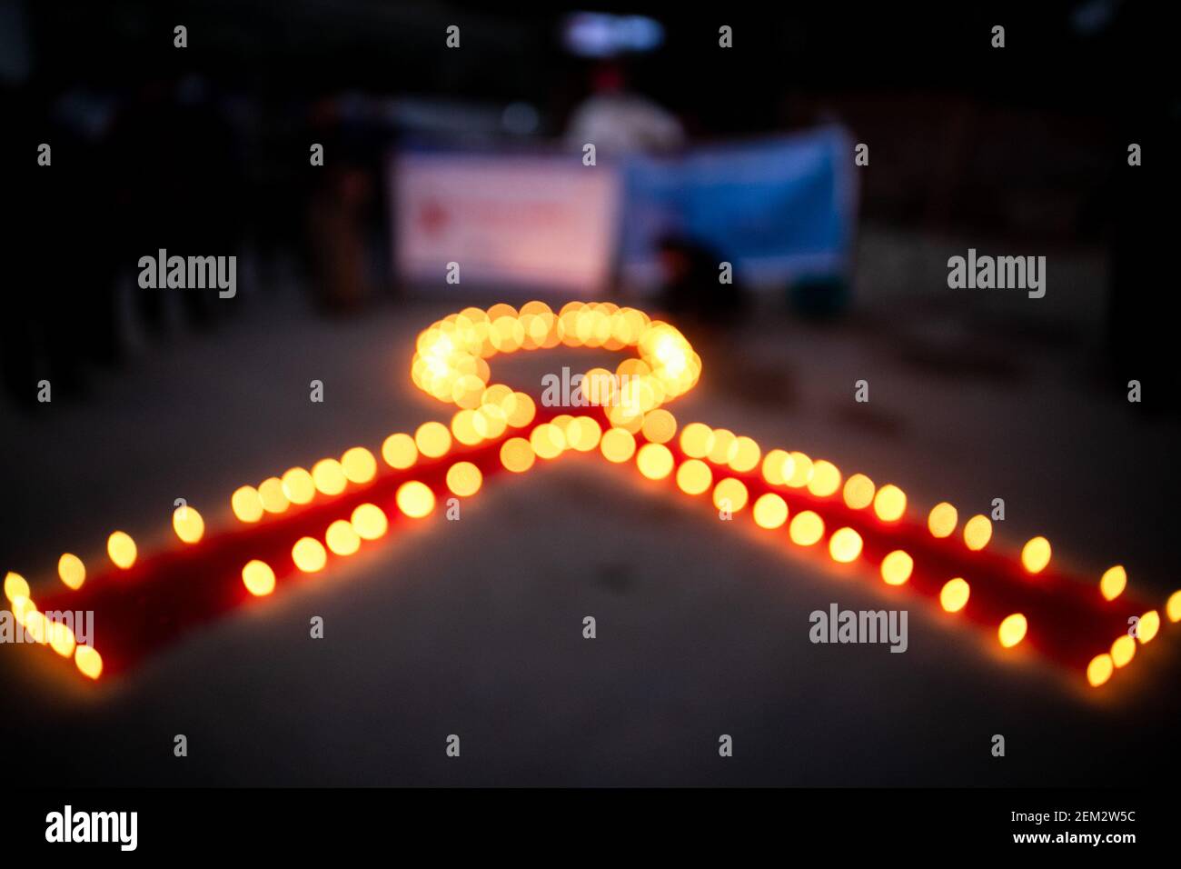 A 'Red Ribbon' (recognized symbol for AIDS awareness) is formed with ...