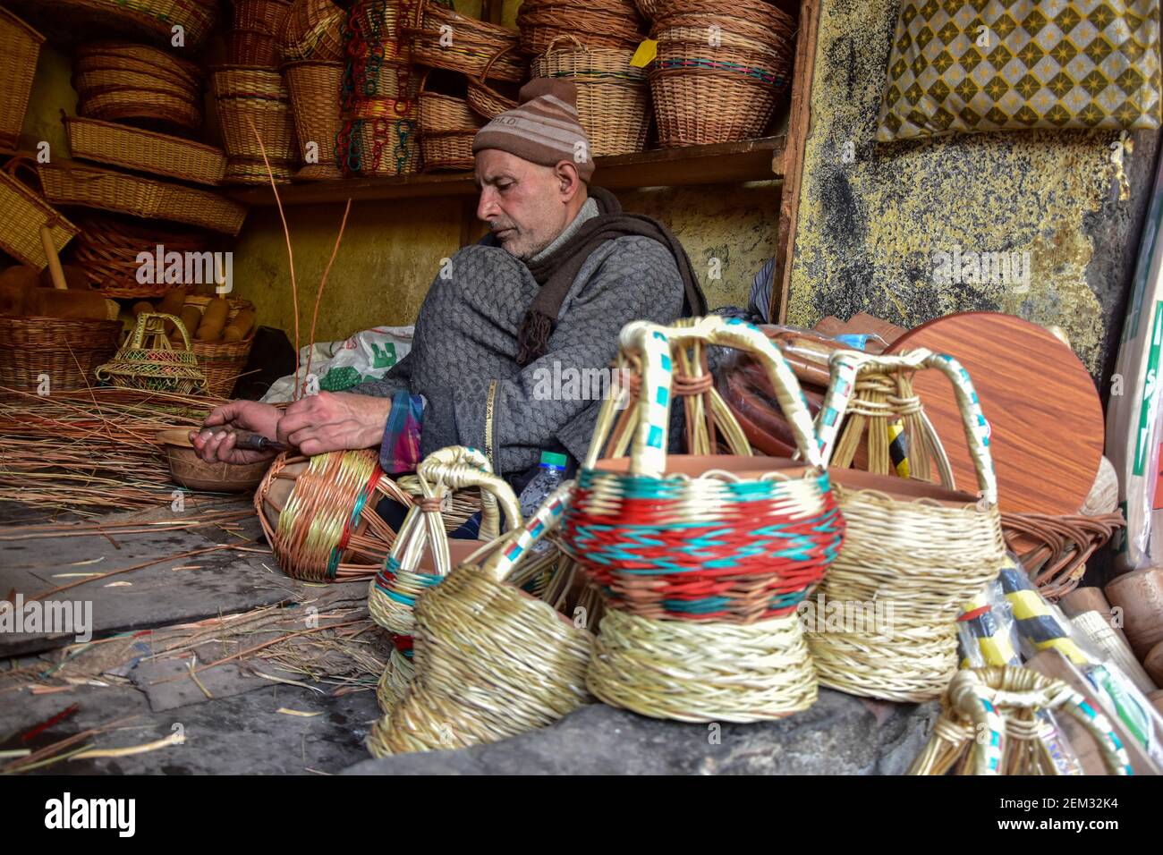 A Kashmiri man makes a "Kangri", a traditional fire pot inside his ...