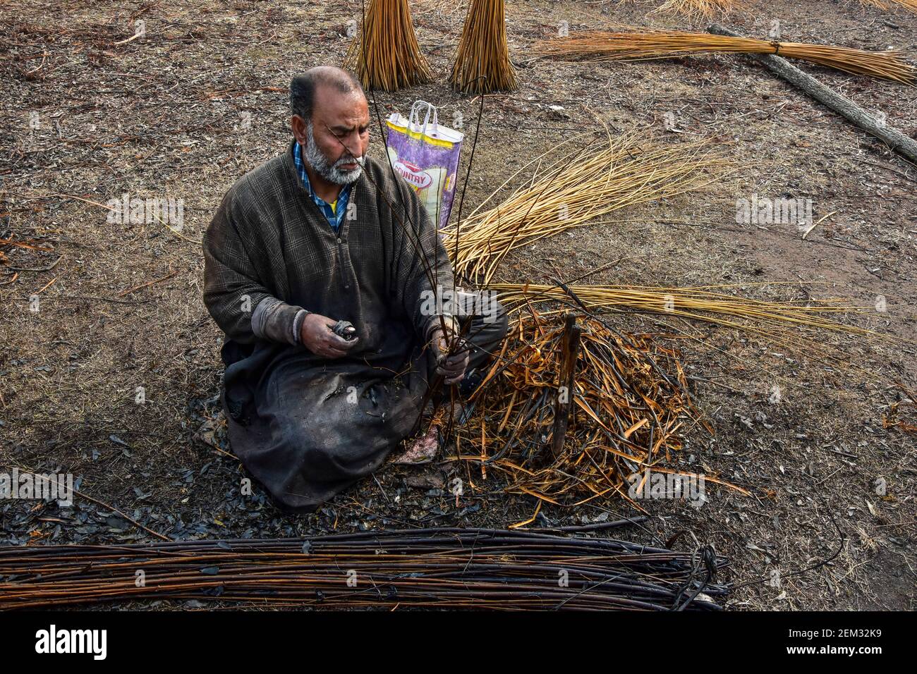 A Kashmiri man prepares twigs to make "Kangris",( Traditional Fire Pots ...