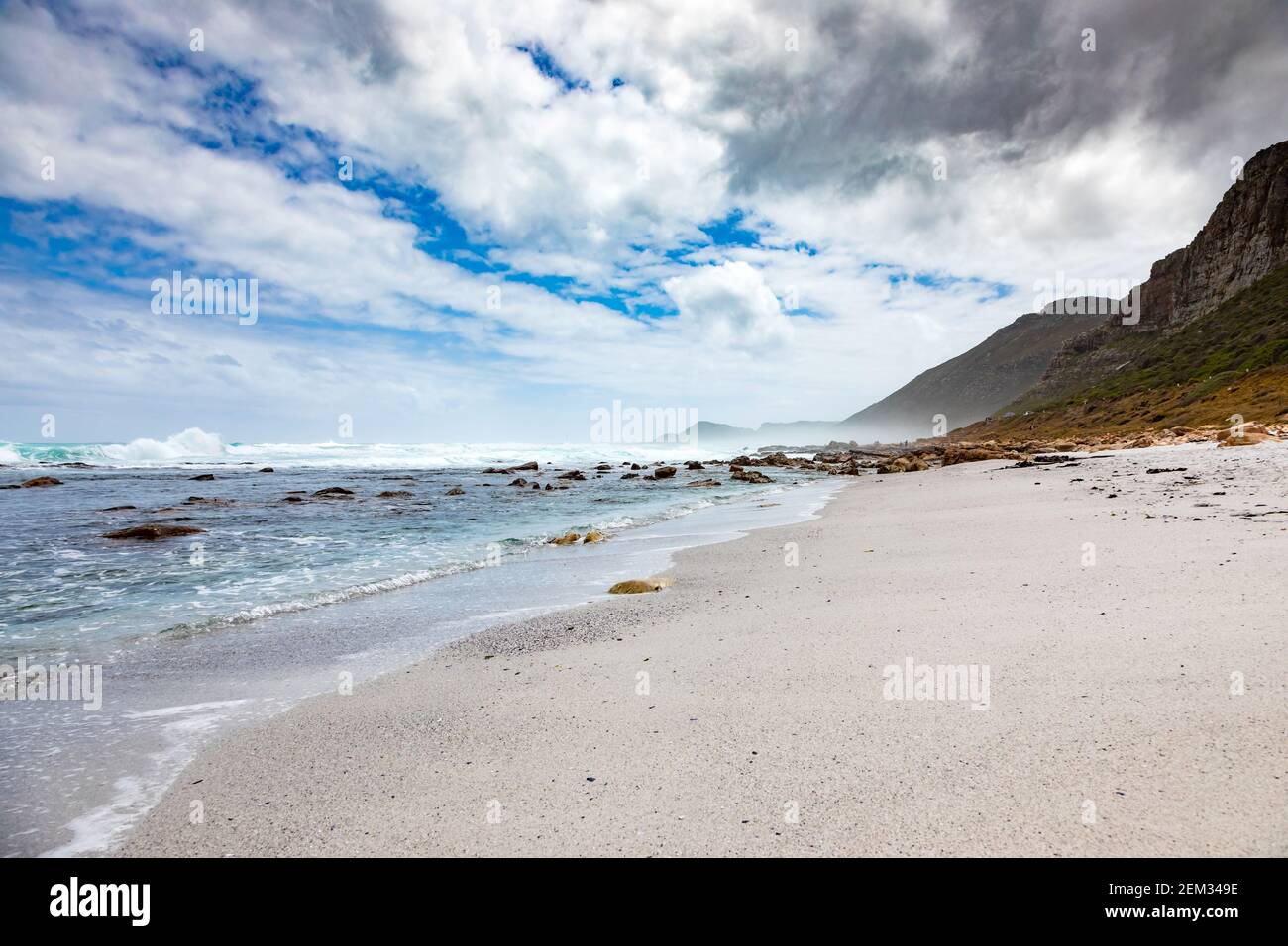 Sandy beach on western side of Cape Town peninsula on a cloudy day ...