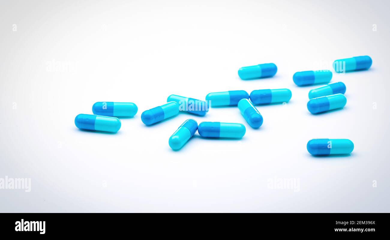 Blue antibiotic capsule pills spread on white background. Antibiotic ...