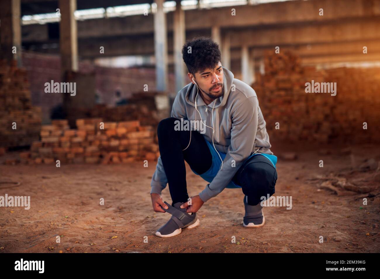 Close up view of sporty active afro american runner man crouching and ...