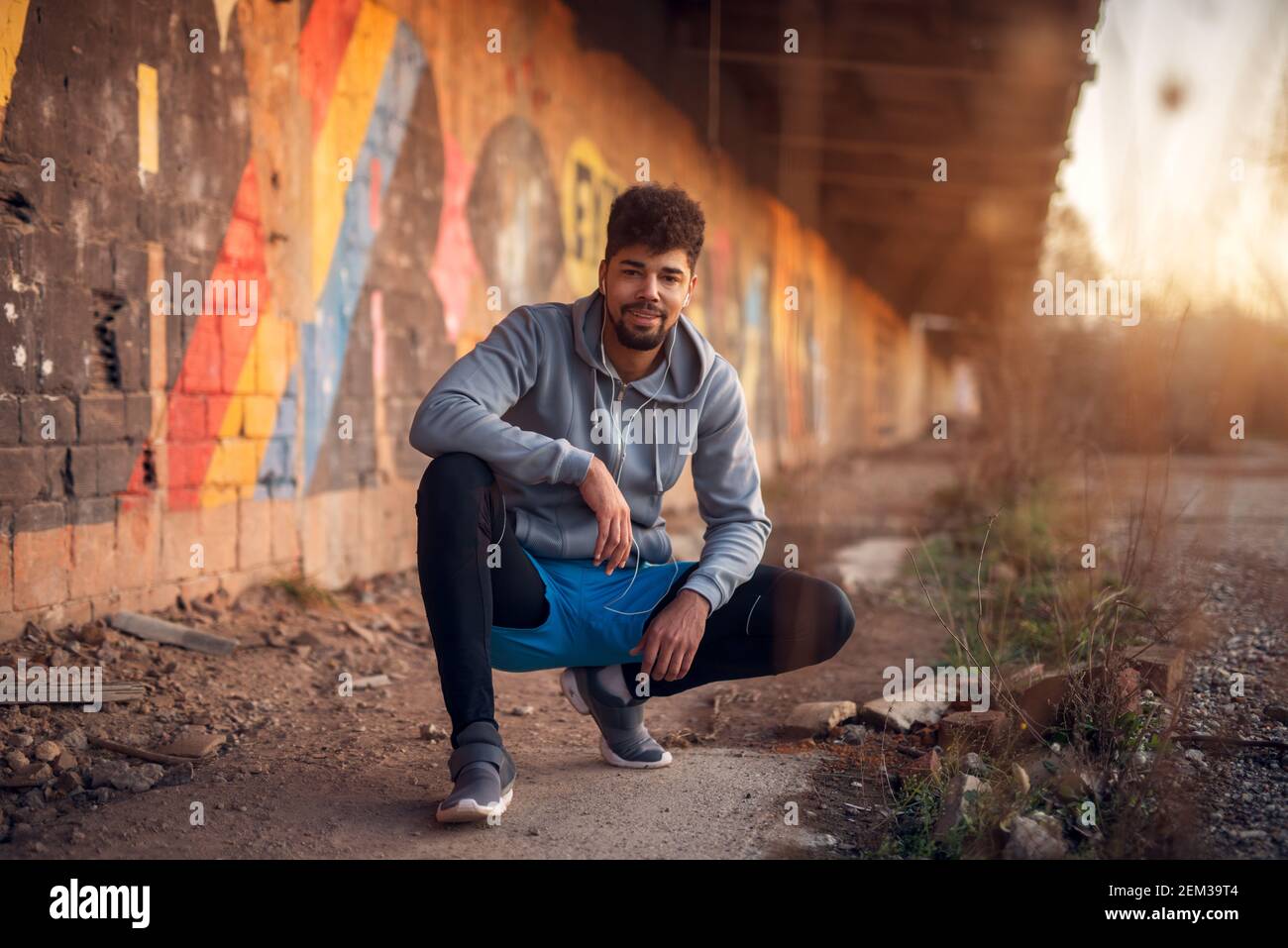 Close up view of sporty active afro american runner man crouching in ...