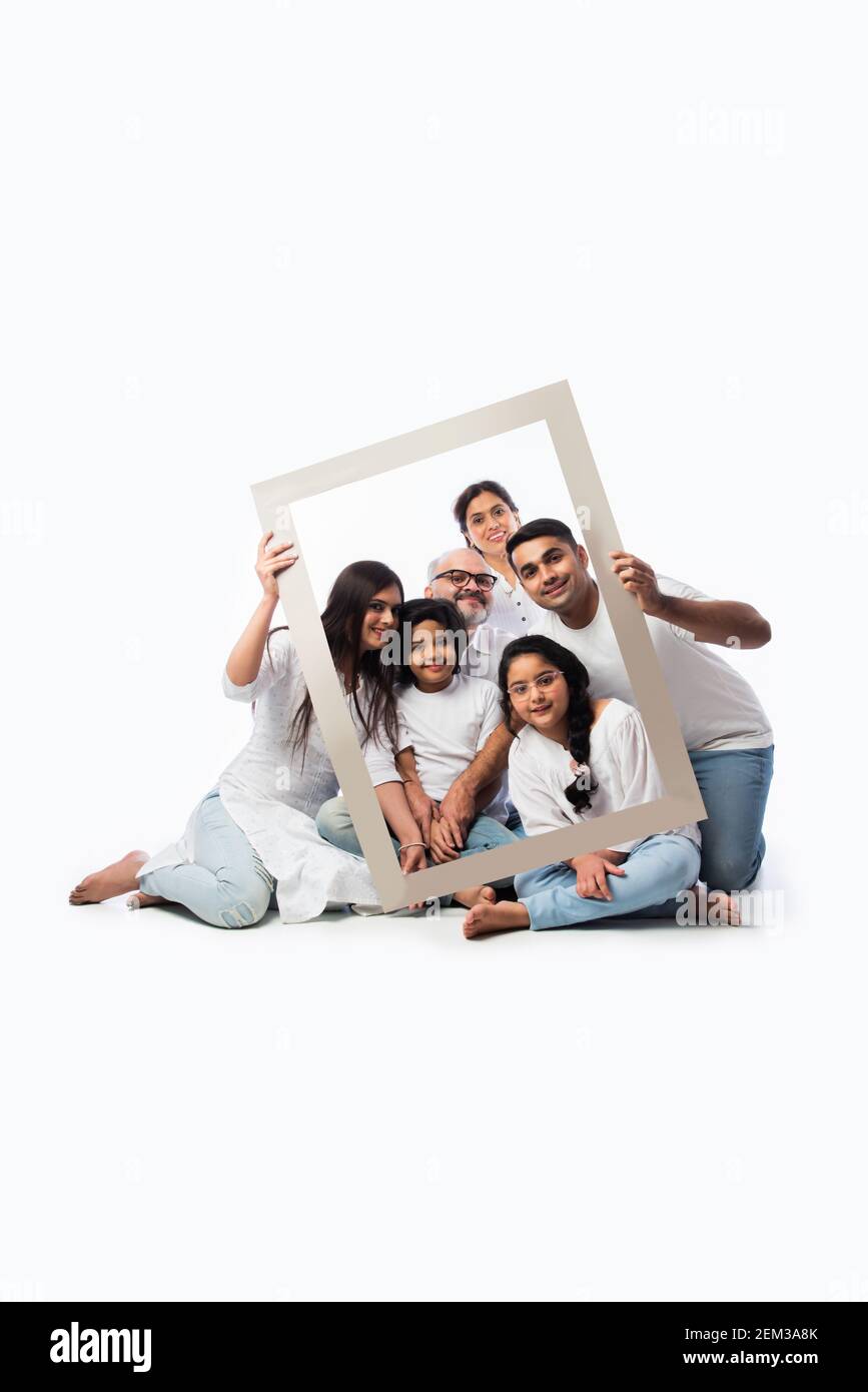 Happy Indian asian multigenerational family of six looking through an ...