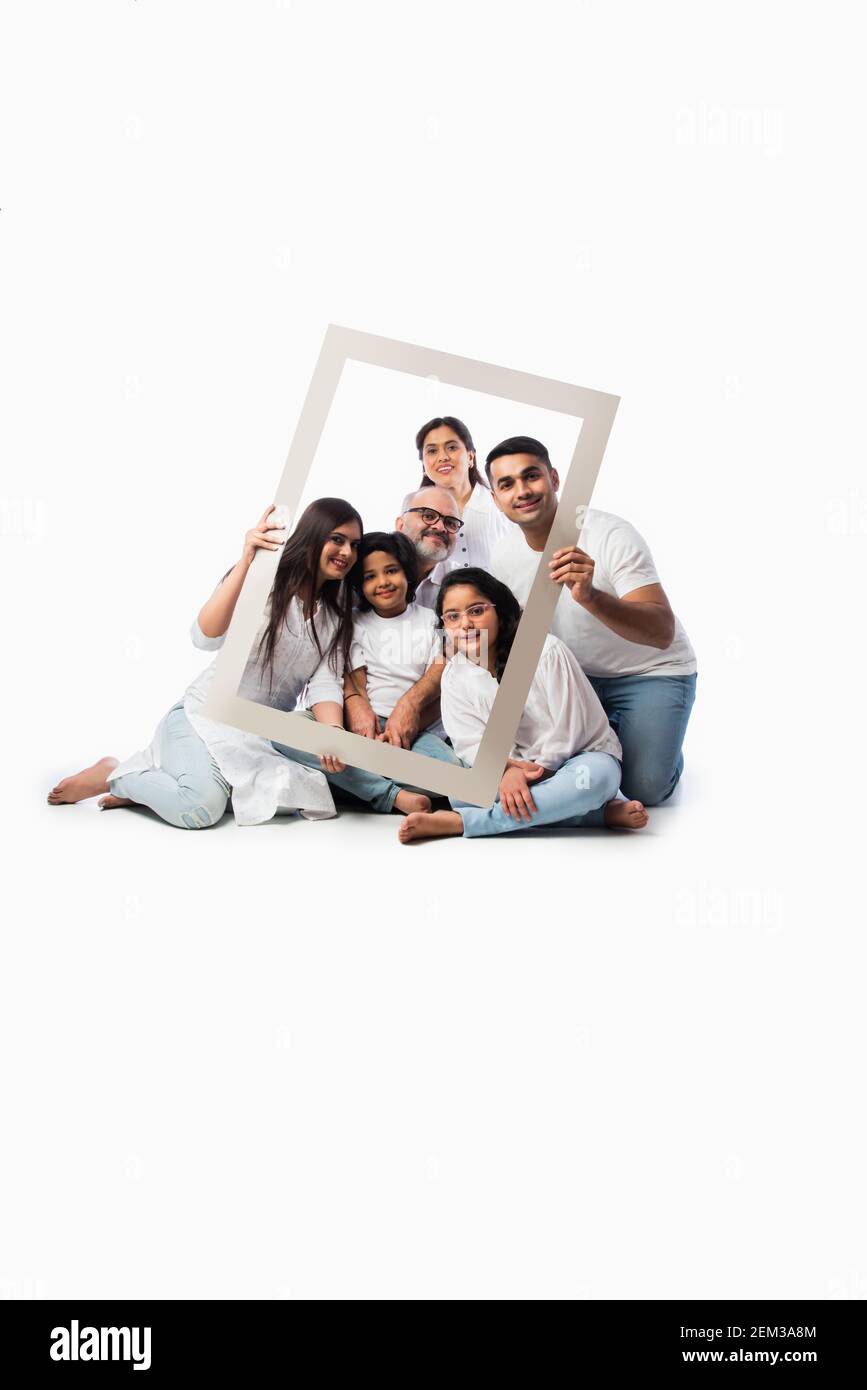Happy Indian asian multigenerational family of six looking through an ...