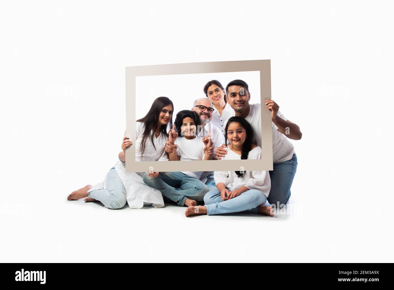 Happy Indian asian multigenerational family of six looking through an ...