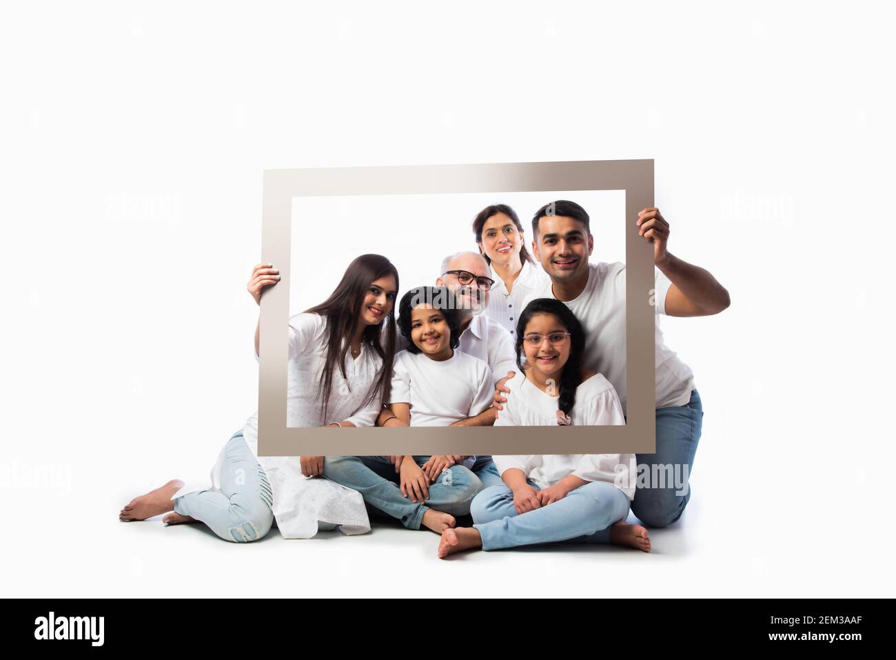 Happy Indian asian multigenerational family of six looking through an ...