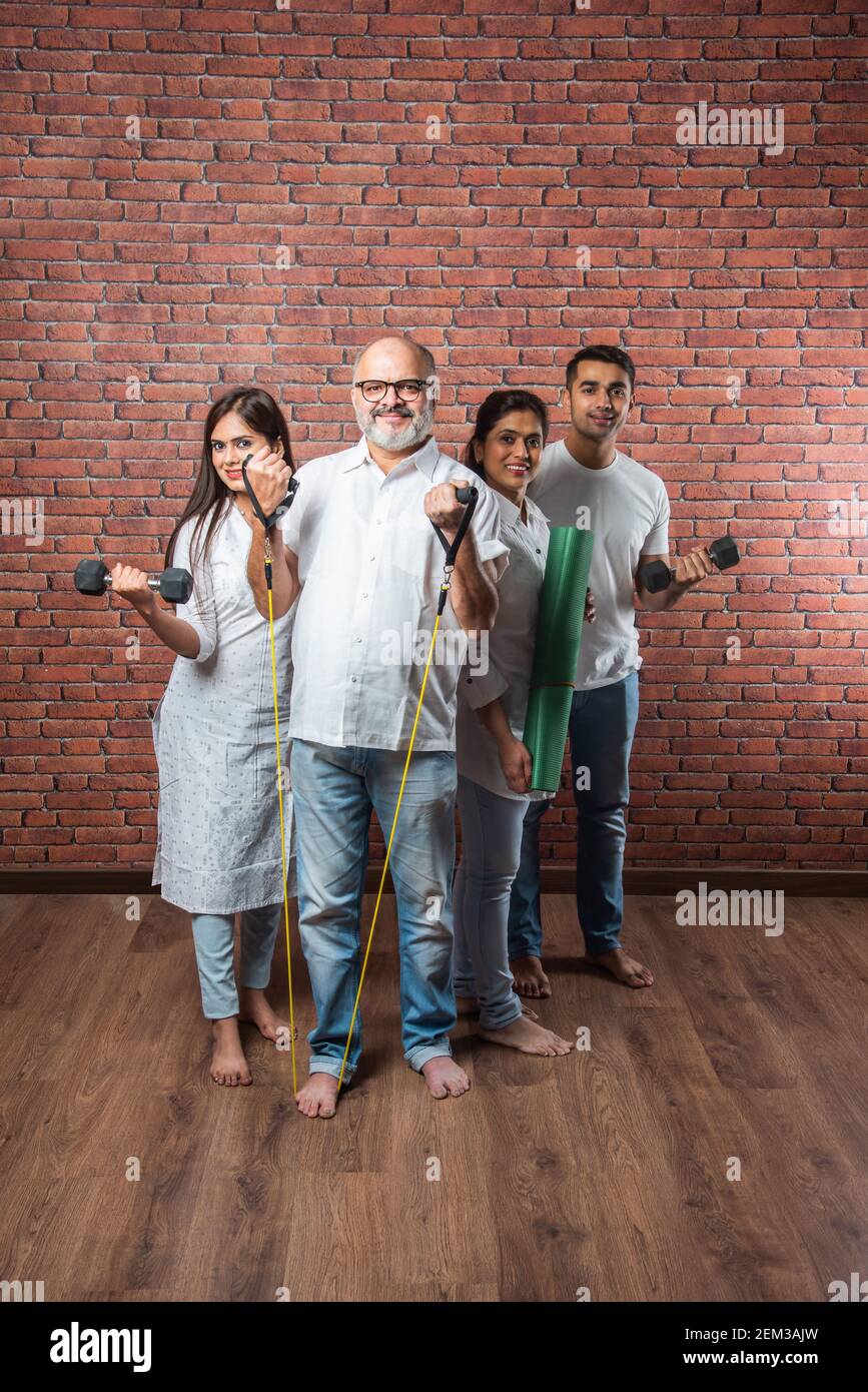 Indian asian Family exercising at home. senior Parents with young kids ...