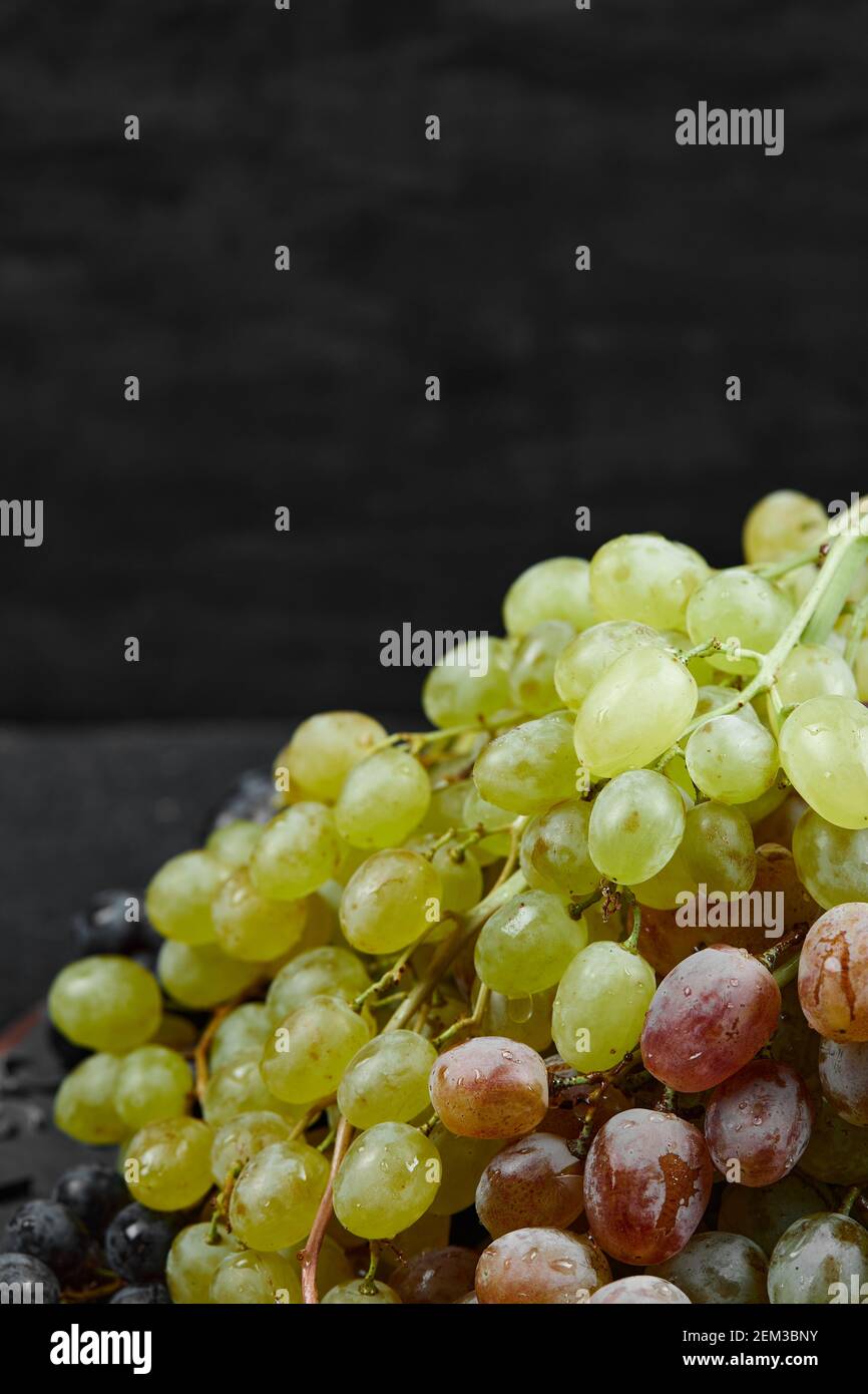 A plate of mixed grapes on dark background Stock Photo - Alamy