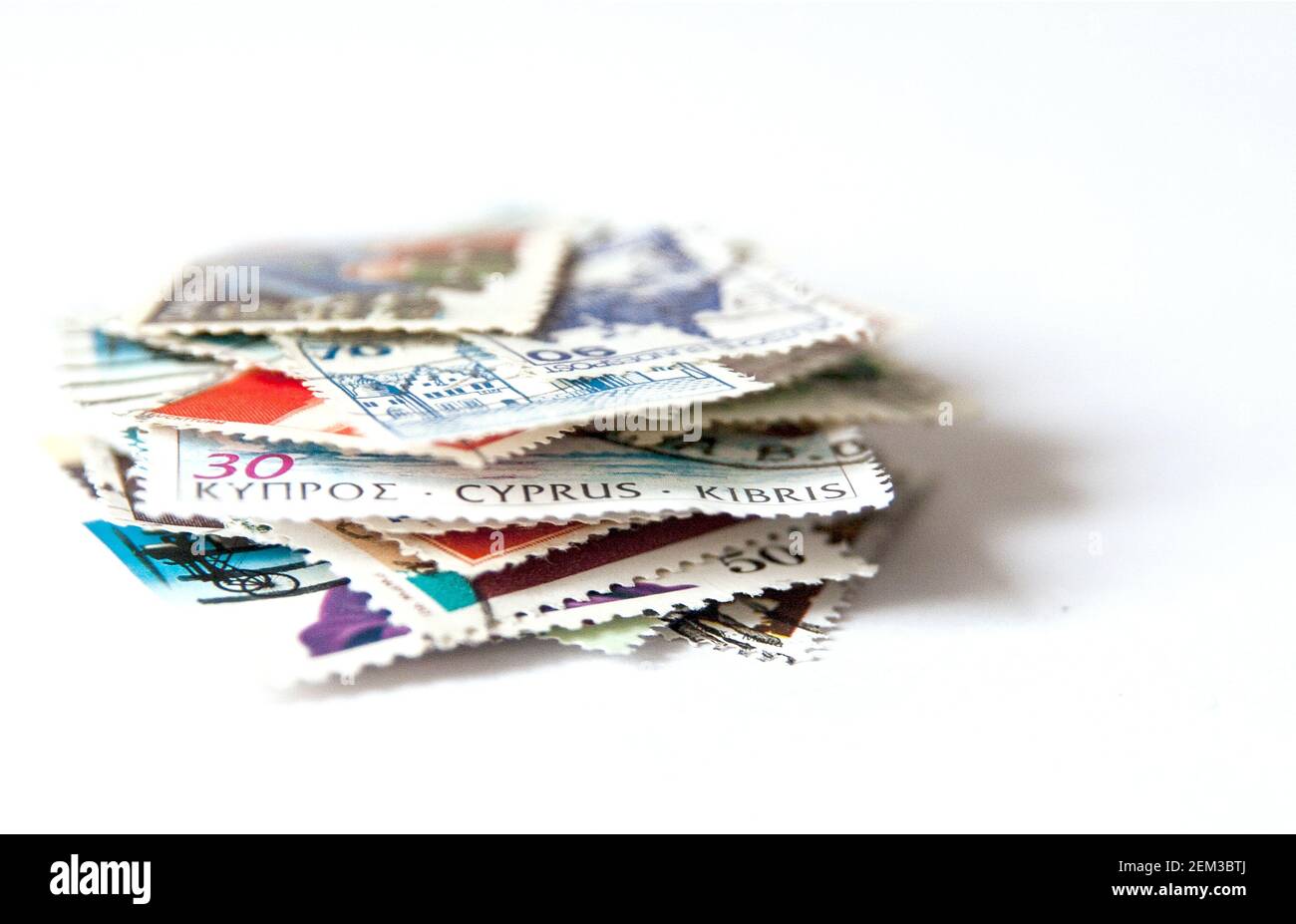 Pile of Postage Stamps isolated on white background Stock Photo - Alamy