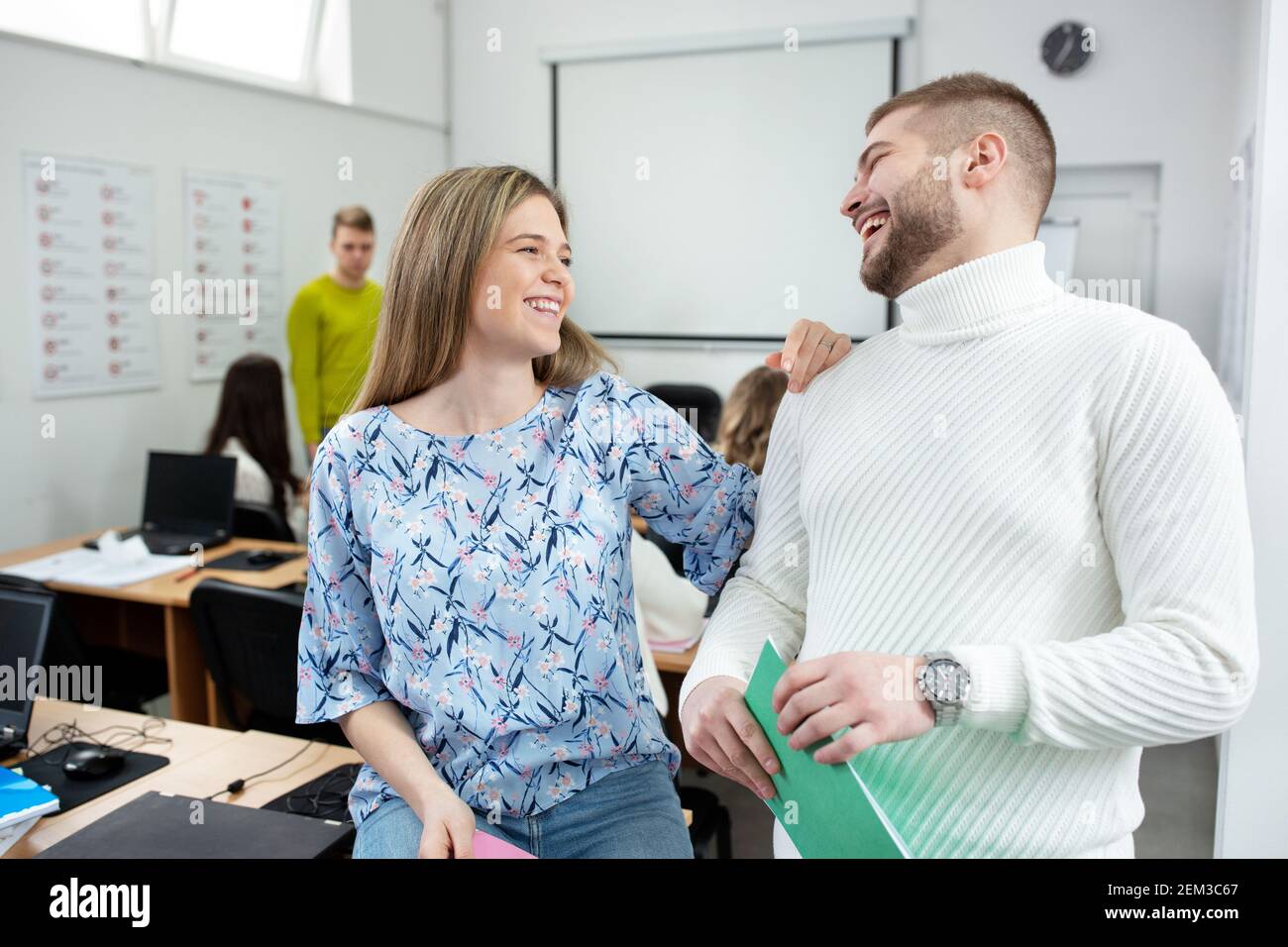 Two students having fun during a break in the classroom Stock Photo - Alamy