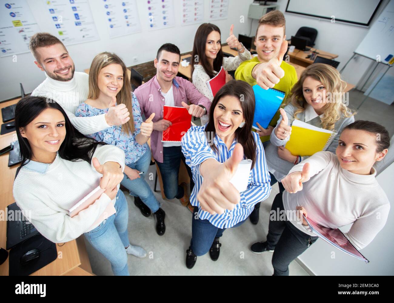 Group of students holding their scripts while taking a picture together ...
