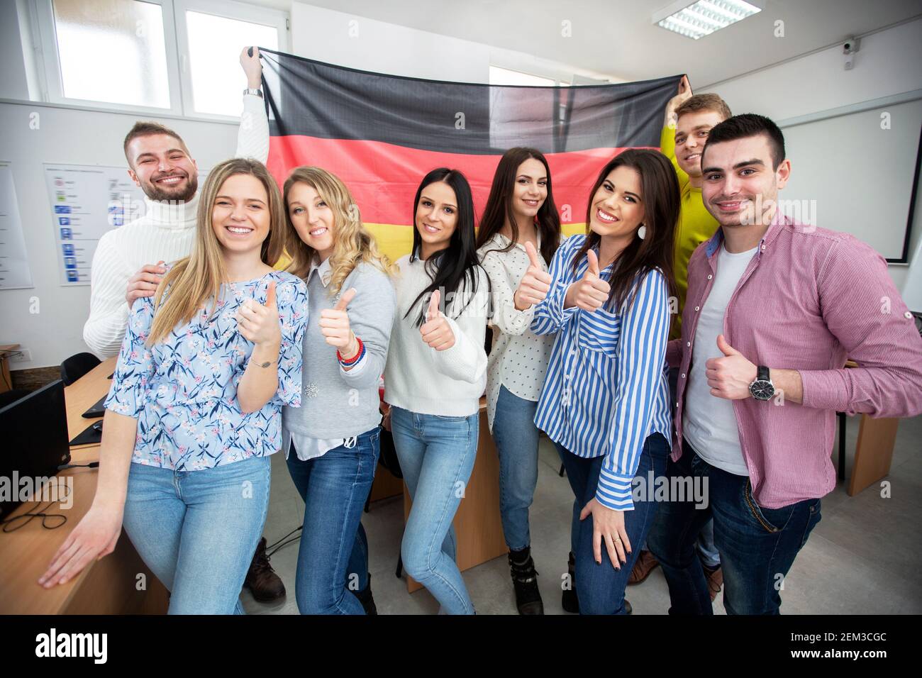 Students taking a picture with German flag in the classroom Stock Photo ...