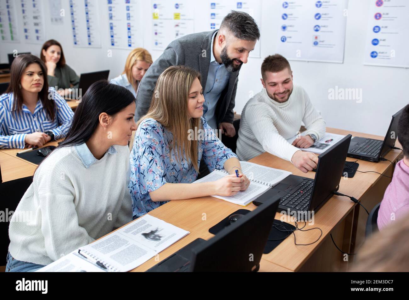 Driving school students in the classroom with their driving instructor ...