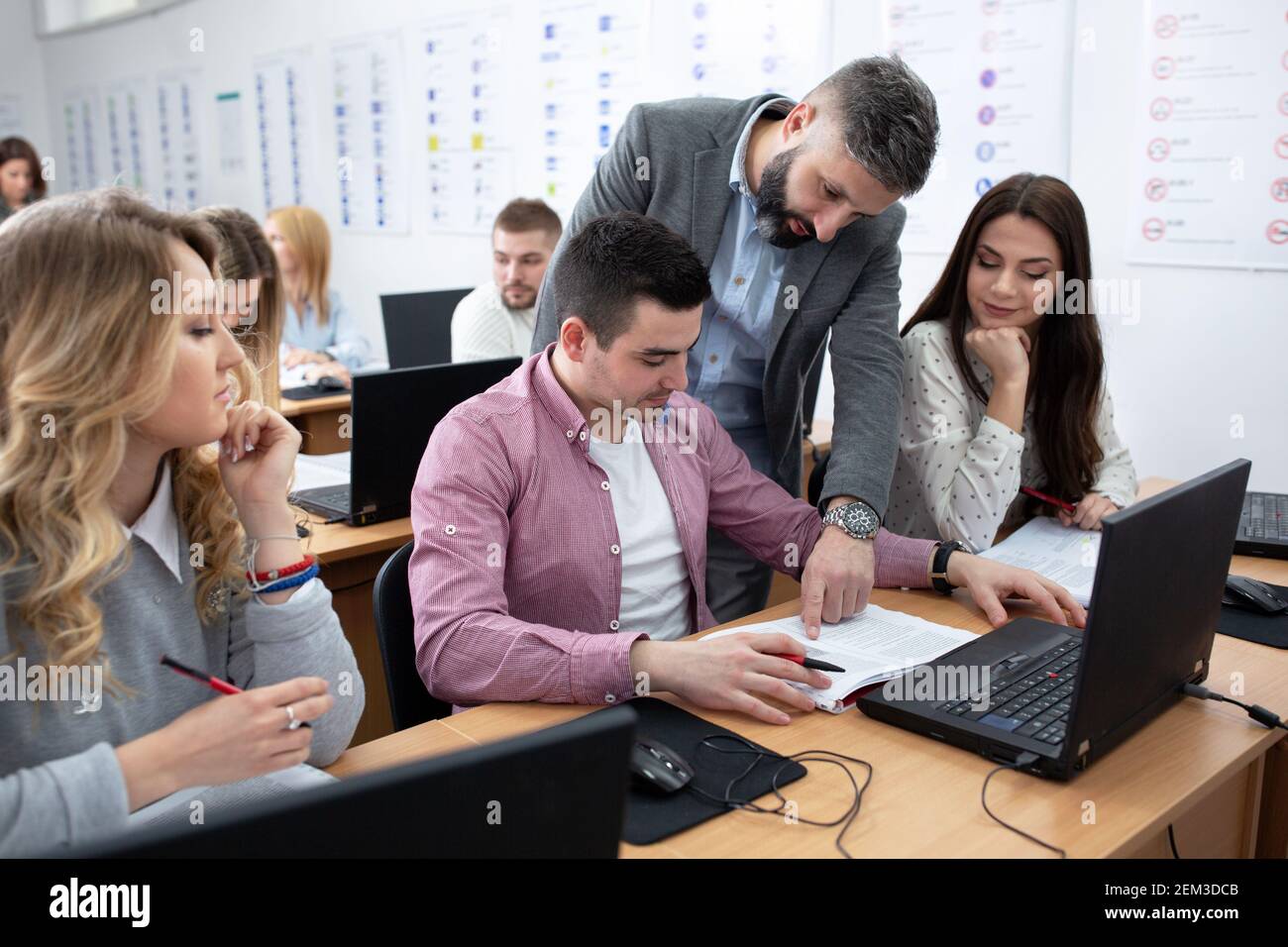 Driving school students in the classroom with their driving instructor ...