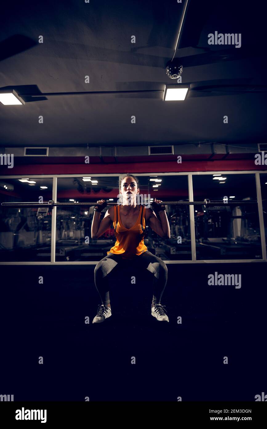 Portrait of motivated young slim athletic fitness woman crouch and ...