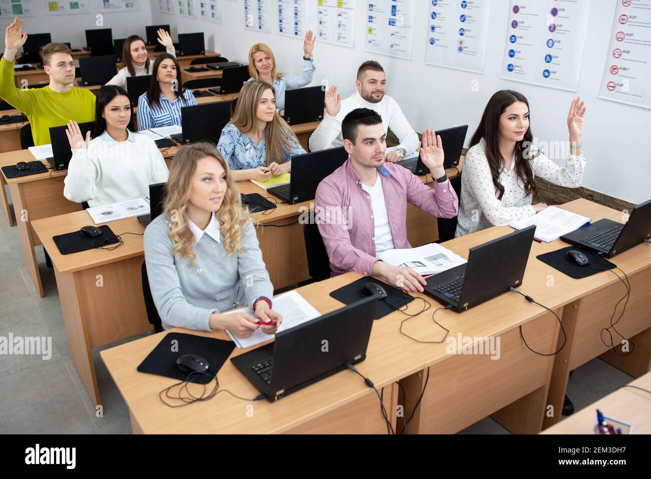 Group of curious students in class raising questions about the matter ...